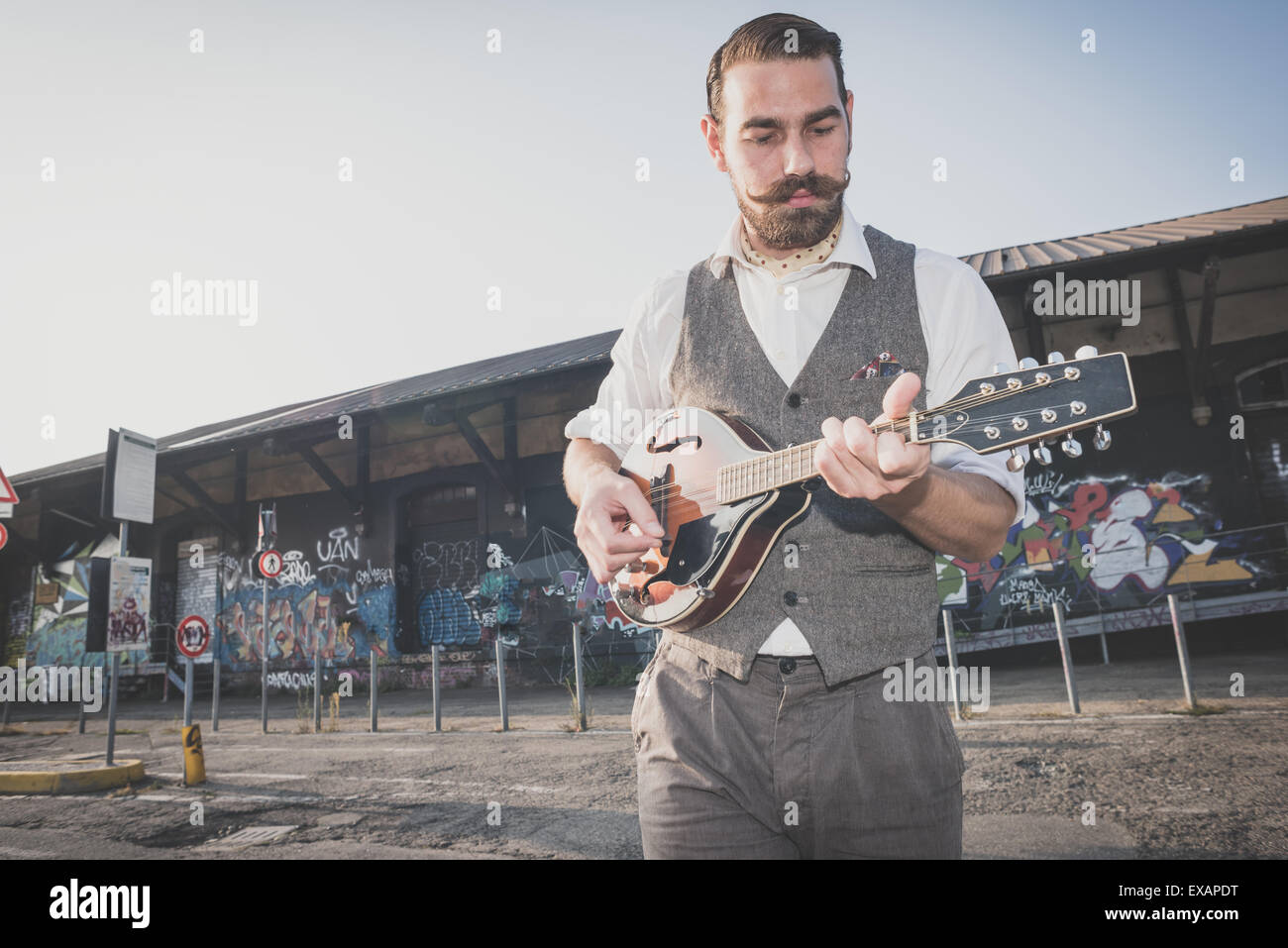handsome big moustache hipster man playing mandolin in the city Stock ...