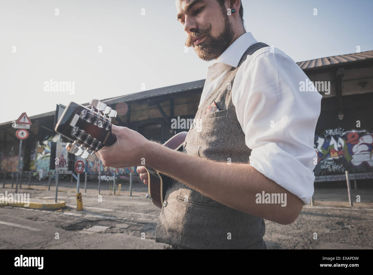 handsome big moustache hipster man playing mandolin in the city Stock ...