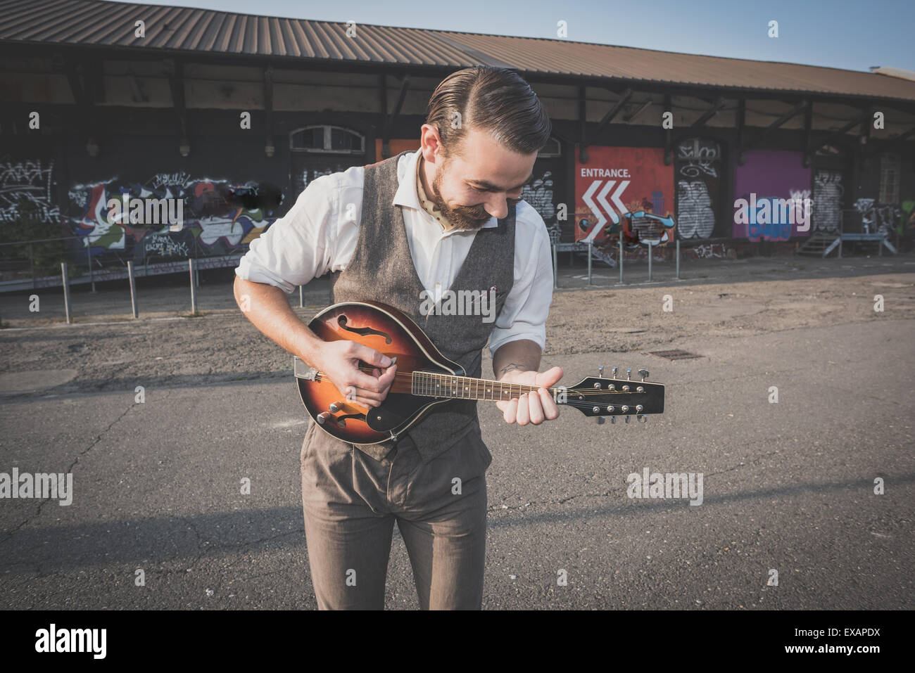 handsome big moustache hipster man playing mandolin in the city Stock ...