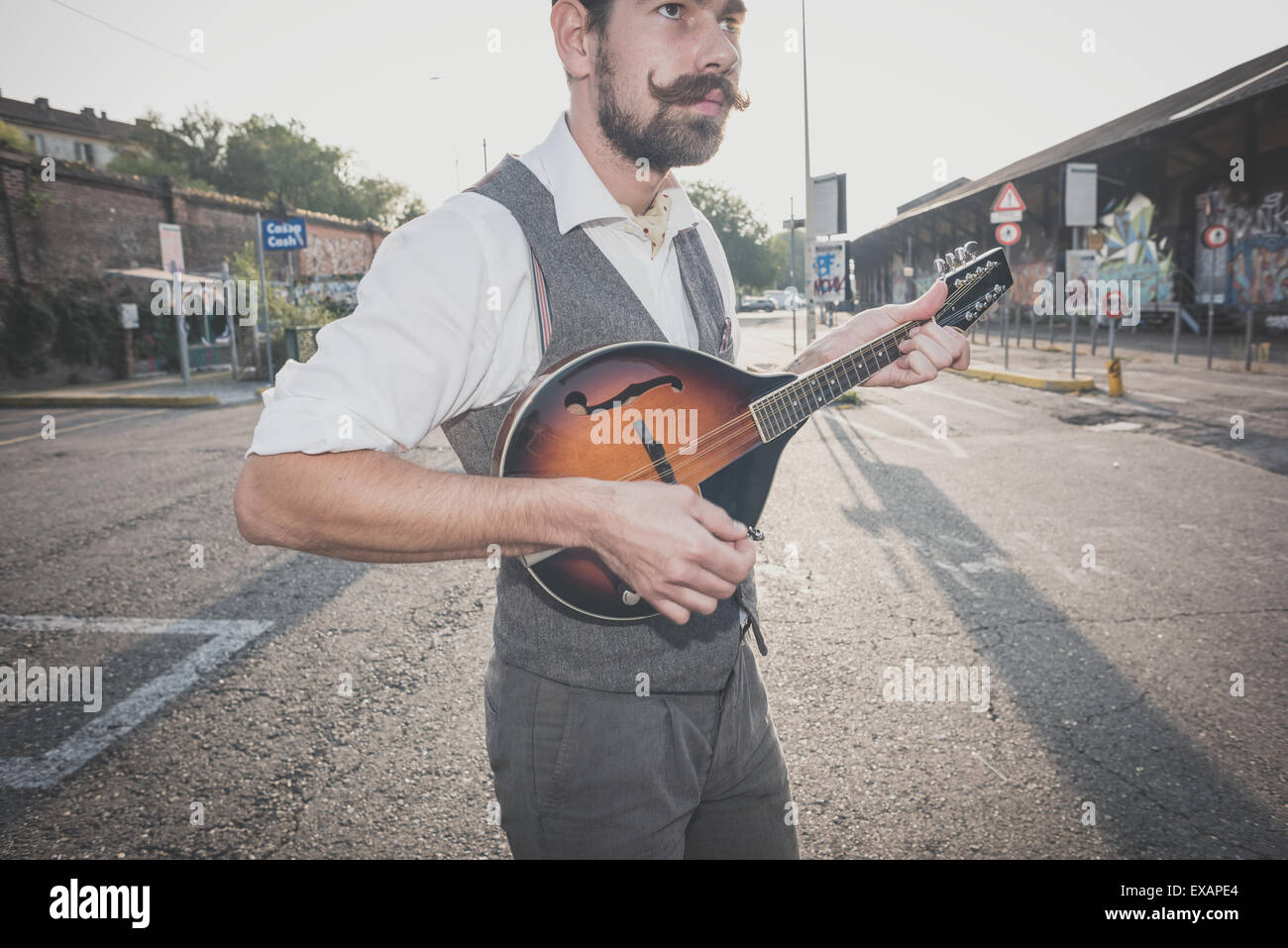 handsome big moustache hipster man playing mandolin in the city Stock ...