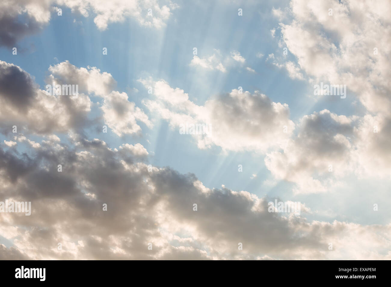 Clouds and sunrays at sunrise Stock Photo - Alamy