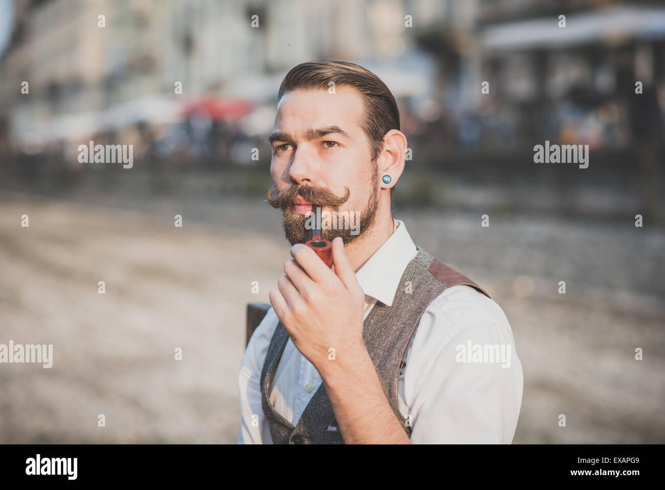 handsome big moustache hipster man smoking pipe in the city Stock Photo ...