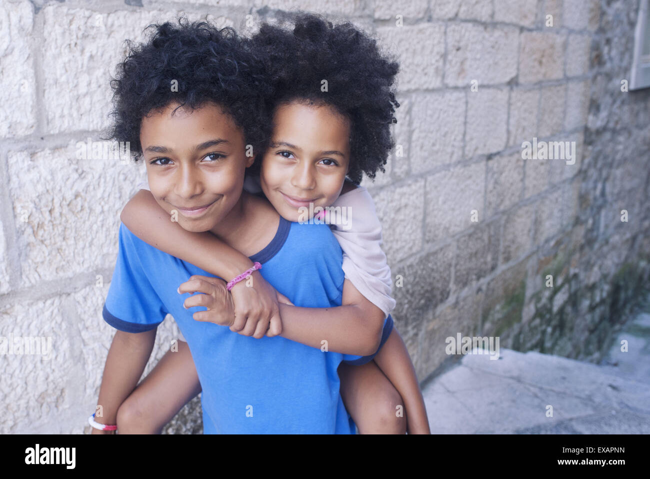 Sister carrying brother hi-res stock photography and images - Alamy
