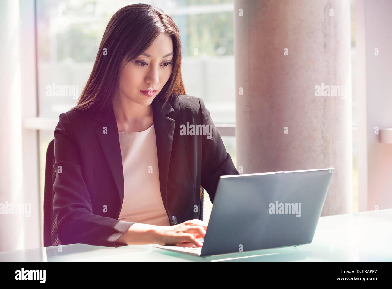 Serious young student works laptop hi-res stock photography and images ...