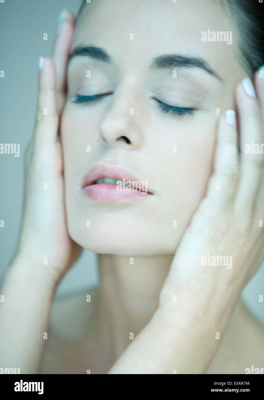 Woman, eyes closed and hands on side of face, portrait Stock Photo - Alamy