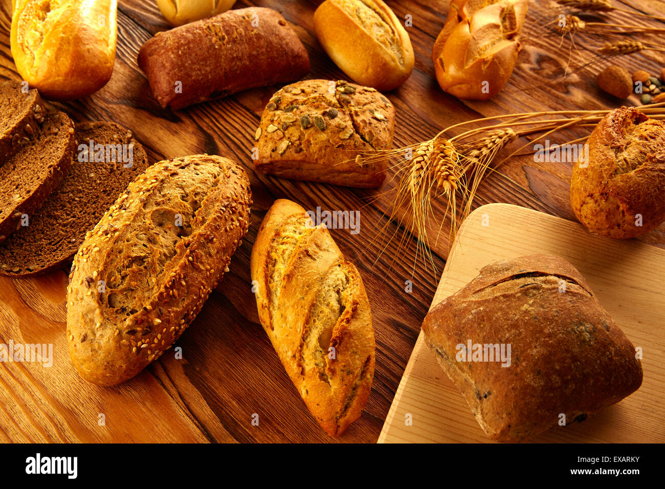 Bread fresh varied mix on golden rustic wood golden table Stock Photo ...
