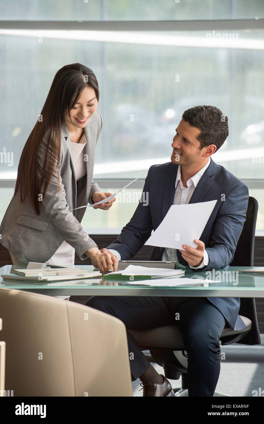Colleagues working together in office Stock Photo - Alamy