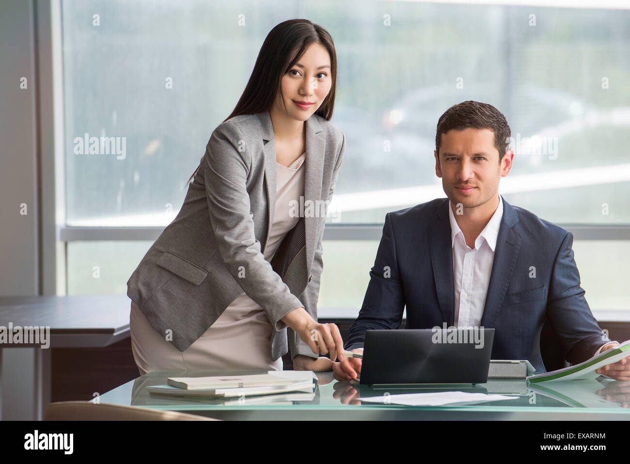Associates working as team in office Stock Photo - Alamy