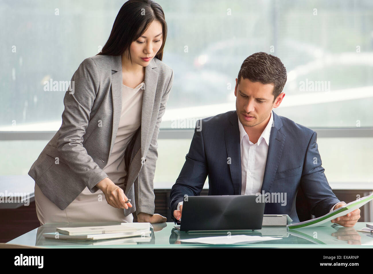 Young manager helping colleague hi-res stock photography and images - Alamy