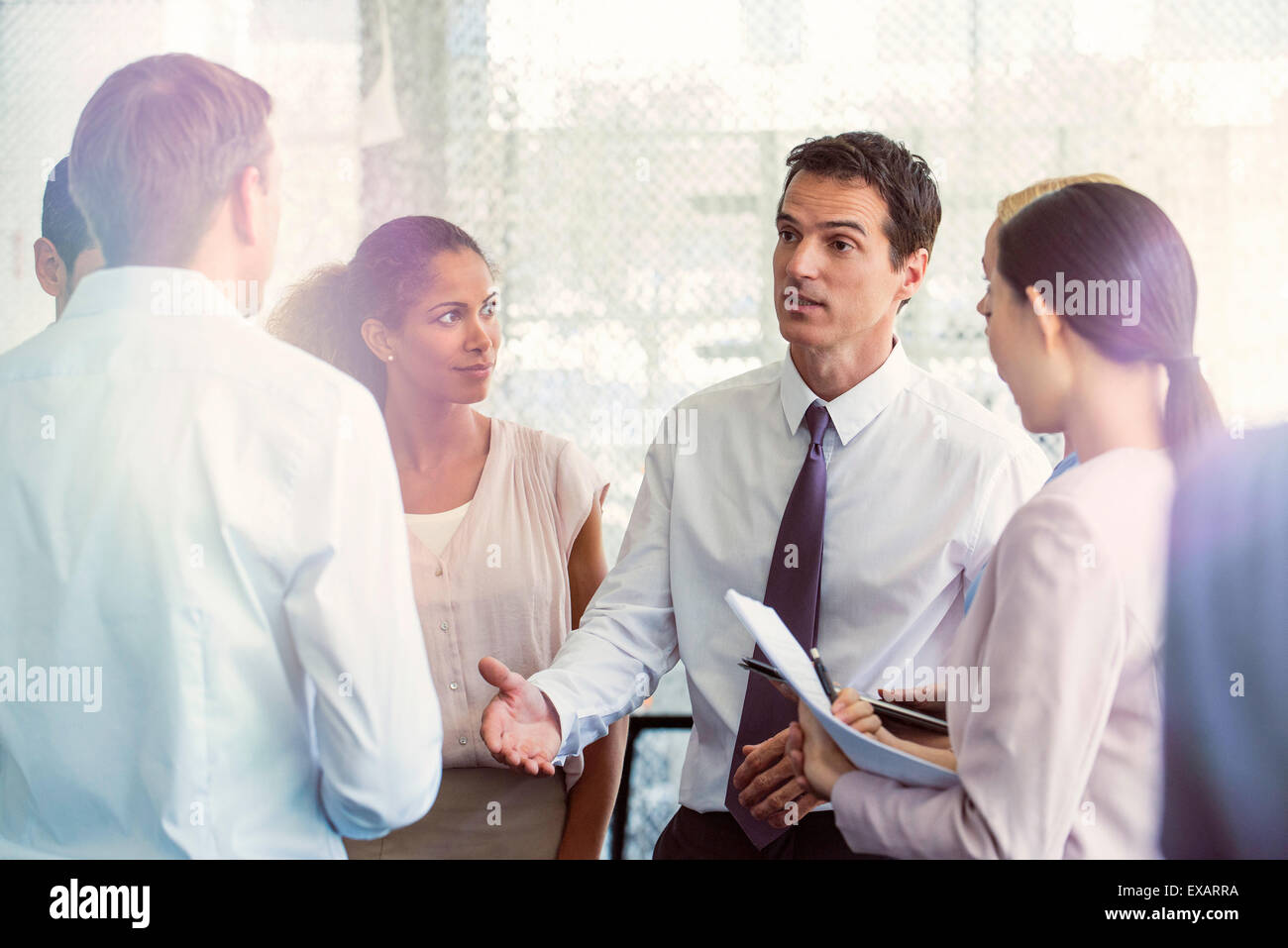 Team members receive direction from supervisor Stock Photo - Alamy