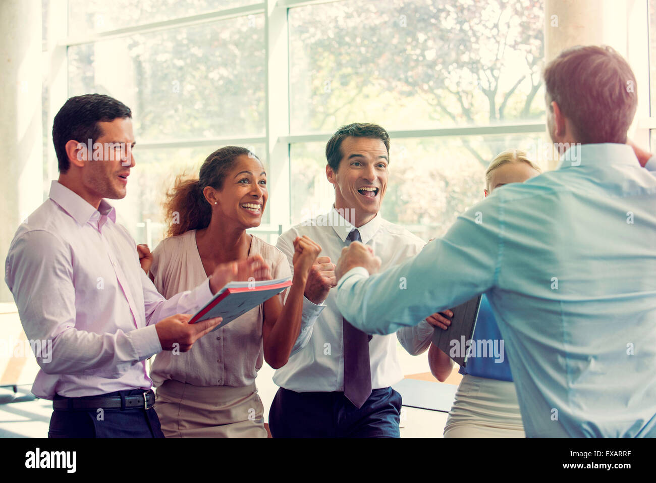Business team members celebrating success Stock Photo - Alamy