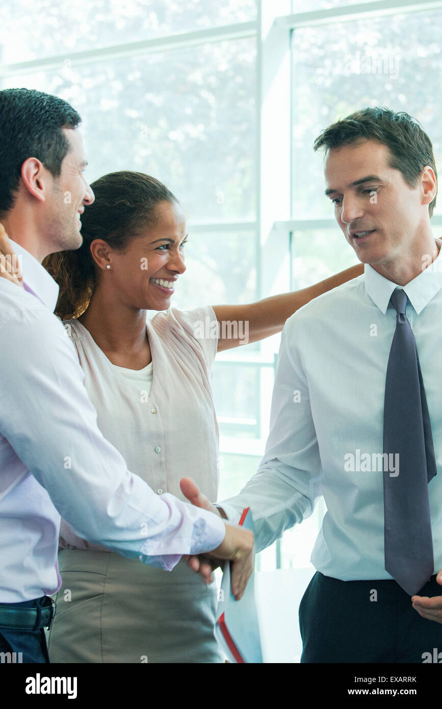 Business team members congratulating each other Stock Photo - Alamy