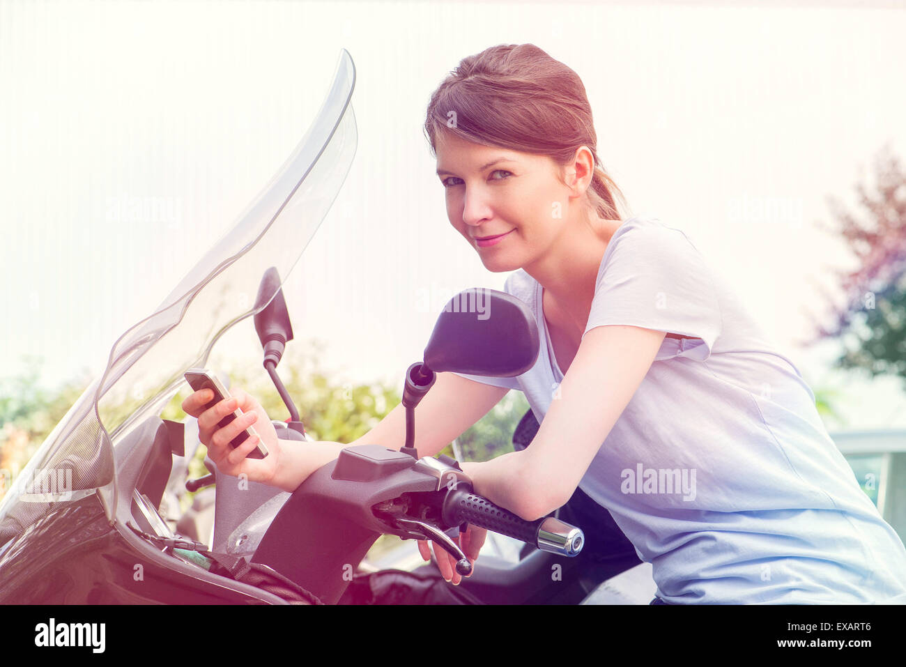 Woman leaning against motorcycle hi-res stock photography and images ...