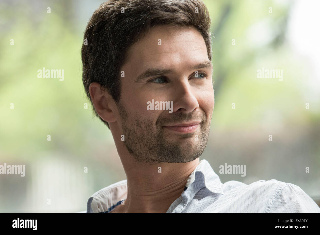 Man smiling contentedly, portrait Stock Photo - Alamy
