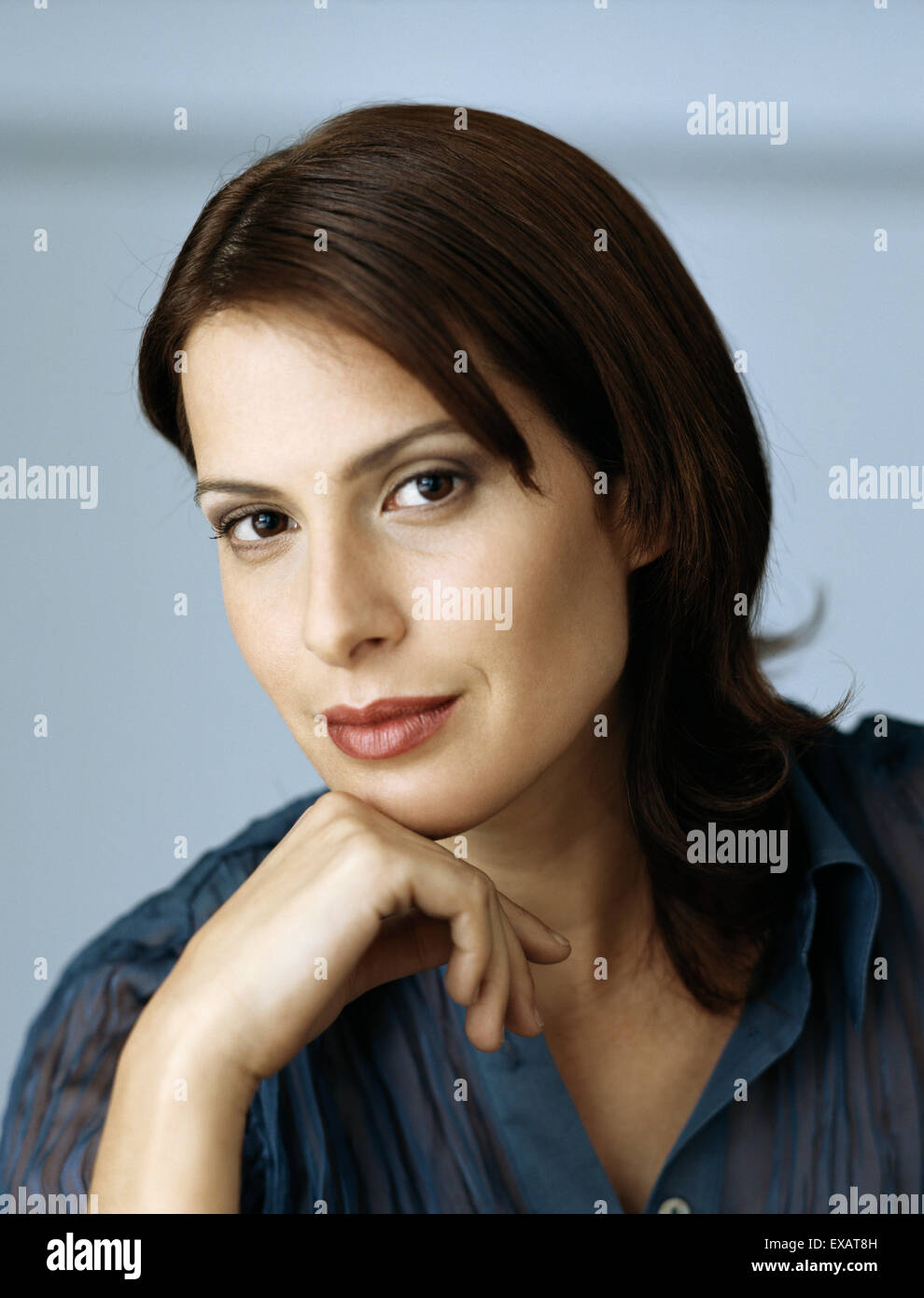 Woman resting chin on hand, portrait Stock Photo - Alamy