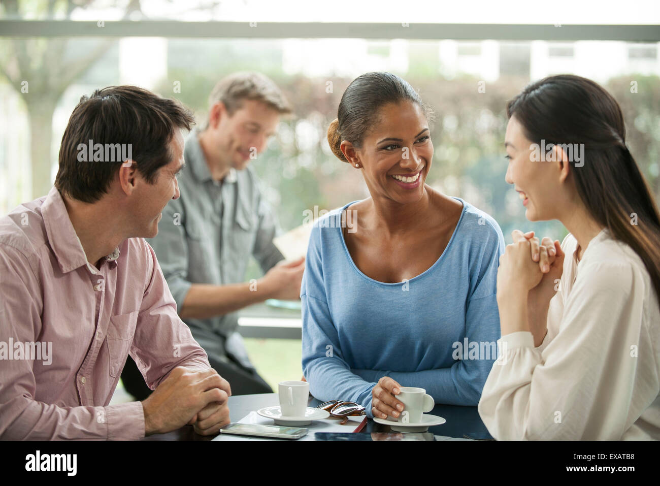 Friends enjoying coffee break Stock Photo - Alamy