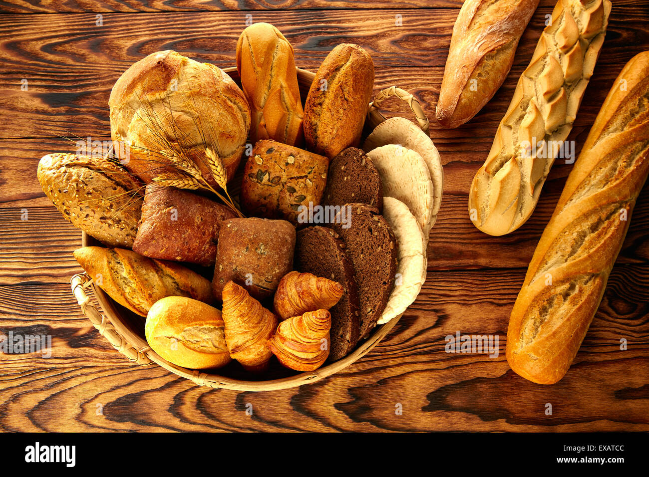 Bread fresh varied mix on golden rustic wood in basket Stock Photo - Alamy
