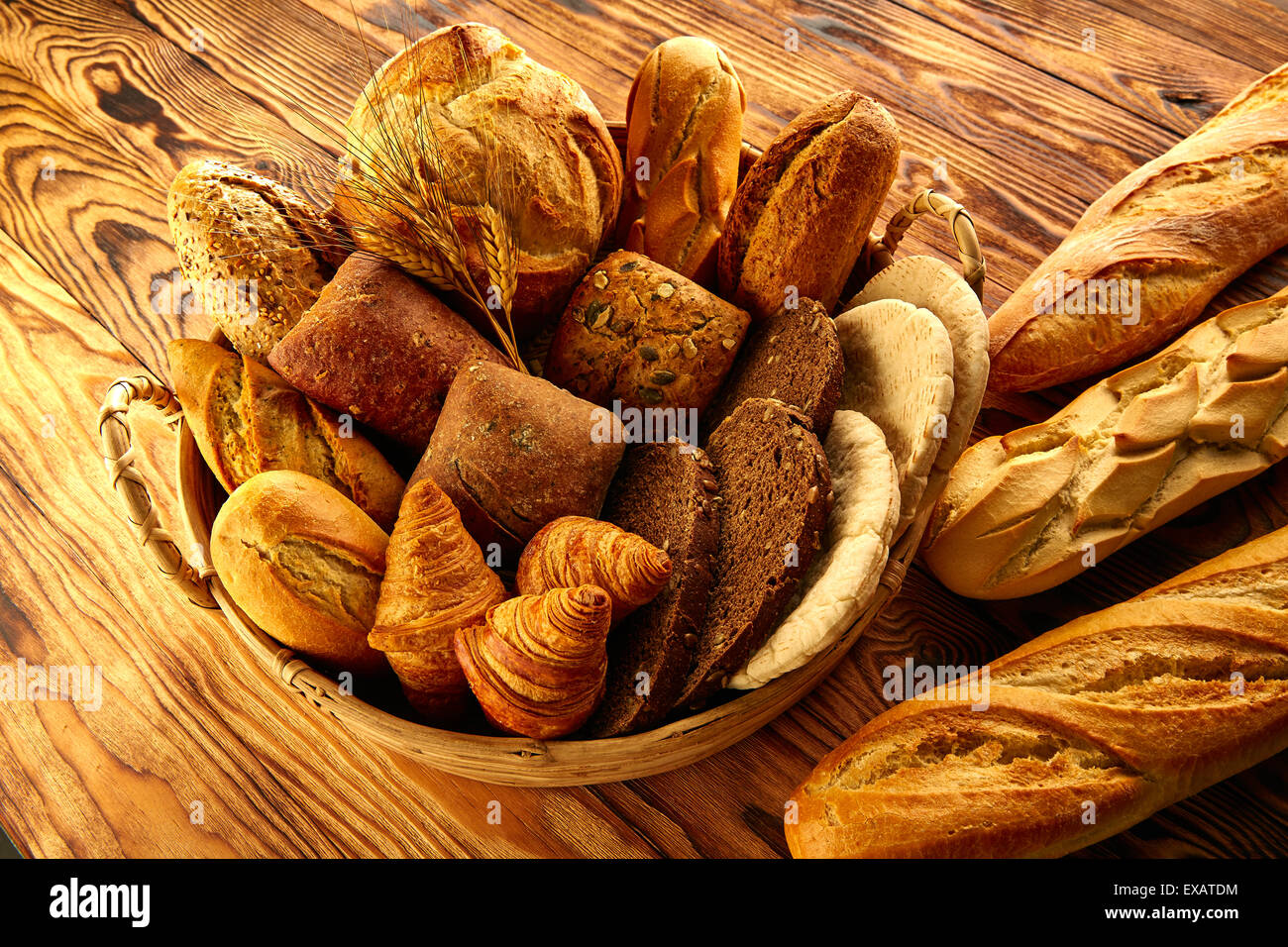 Bread fresh varied mix on golden rustic wood in basket Stock Photo - Alamy