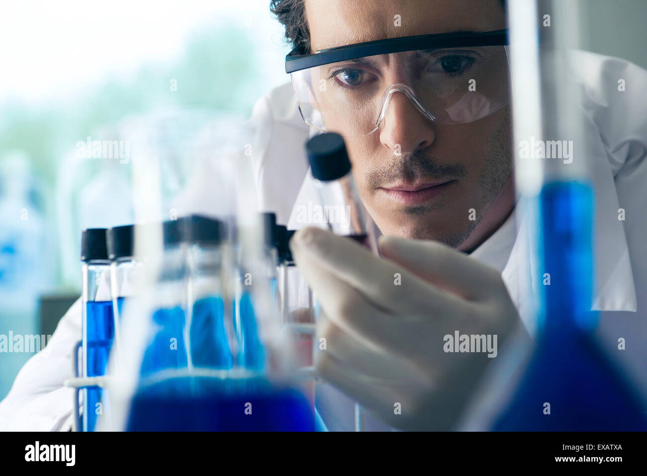 Lab technician conducting experiment in laboratory Stock Photo - Alamy