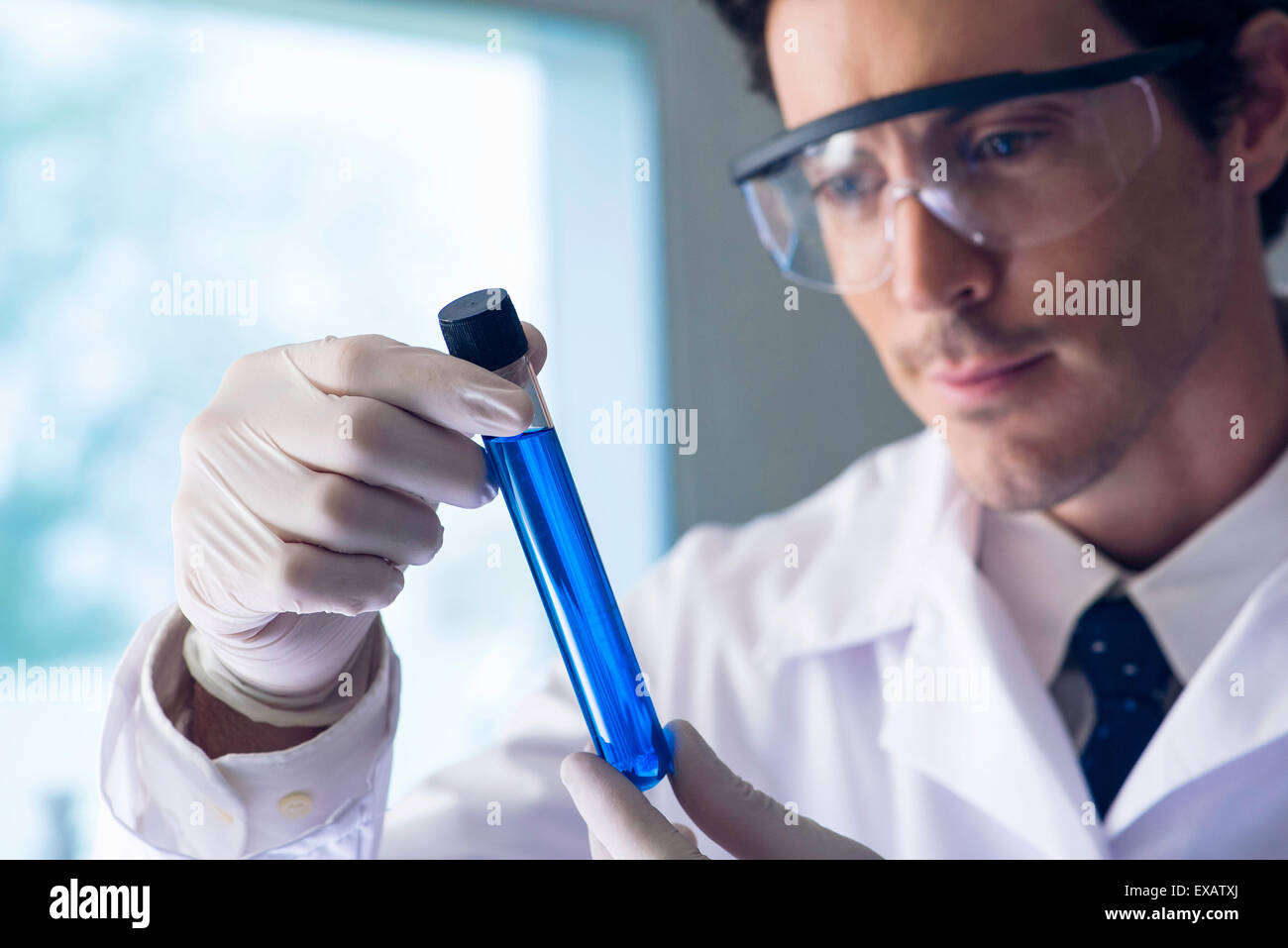 Scientist examining test tube Stock Photo - Alamy