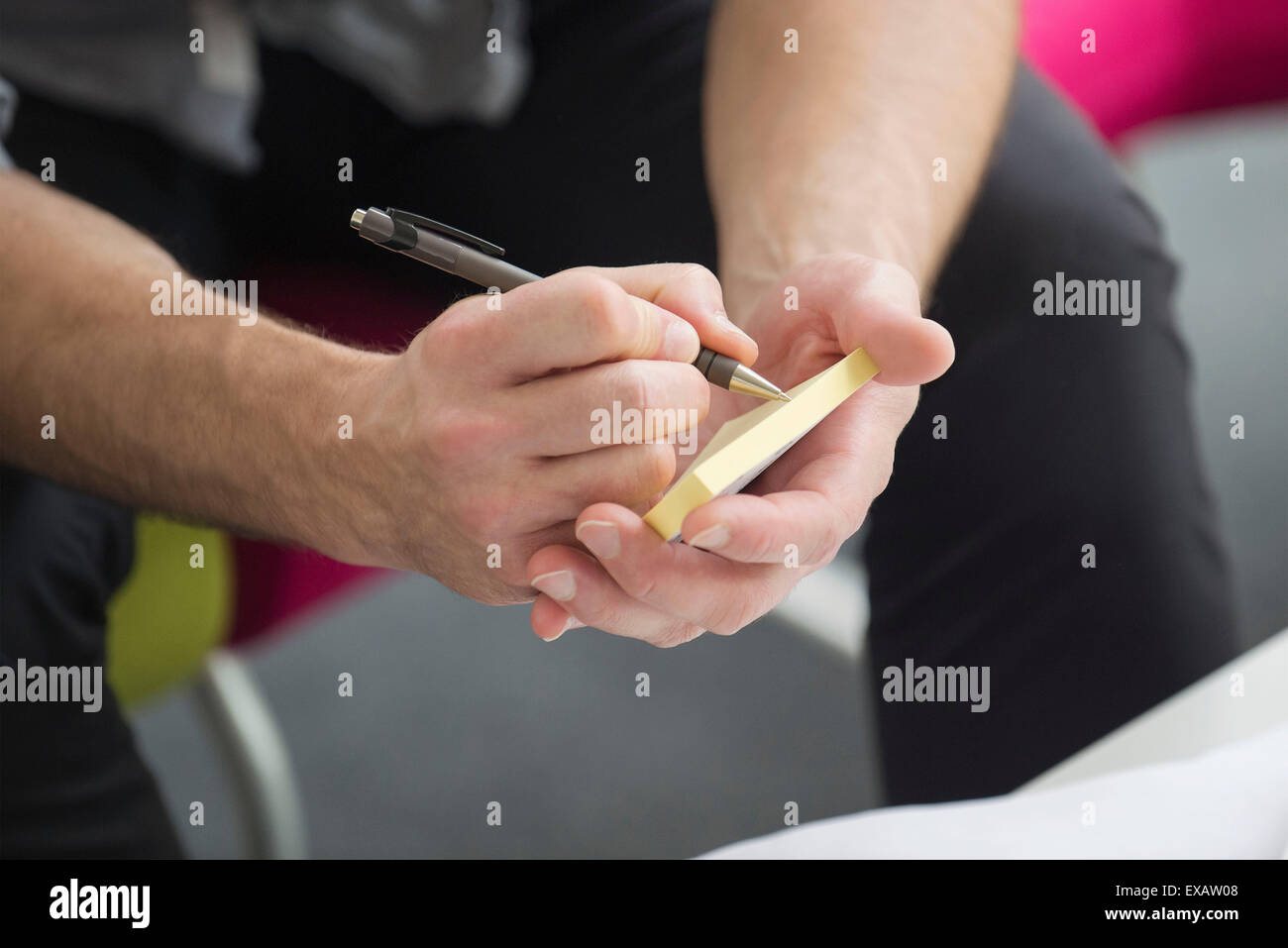 Writing note on sticky pad Stock Photo - Alamy