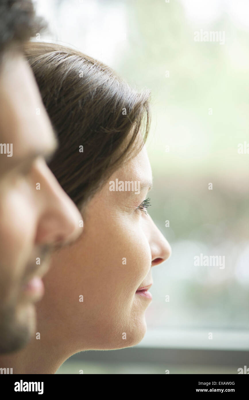 Woman gazing out window, profile Stock Photo - Alamy