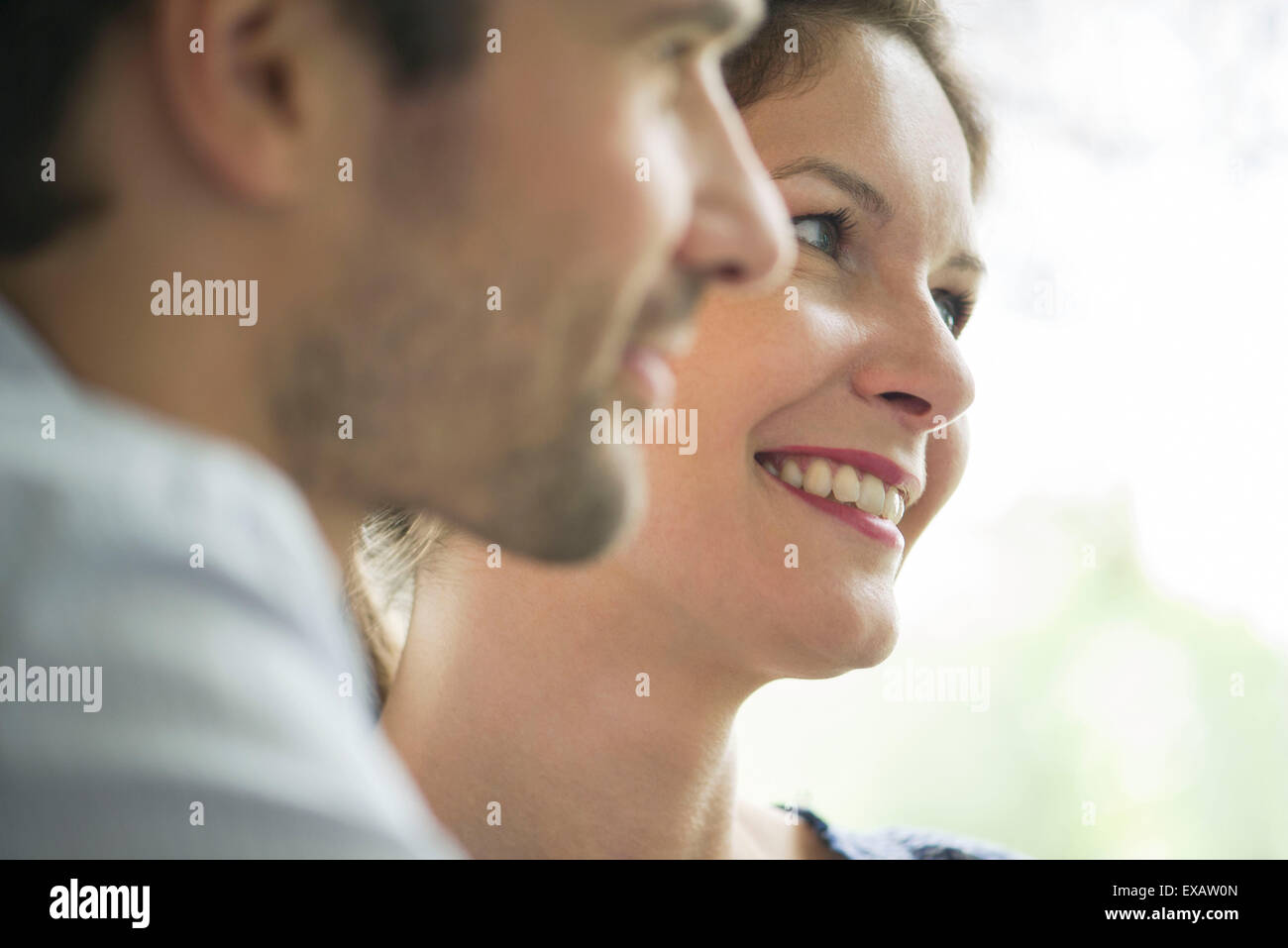 Couple looking away, smiling Stock Photo - Alamy
