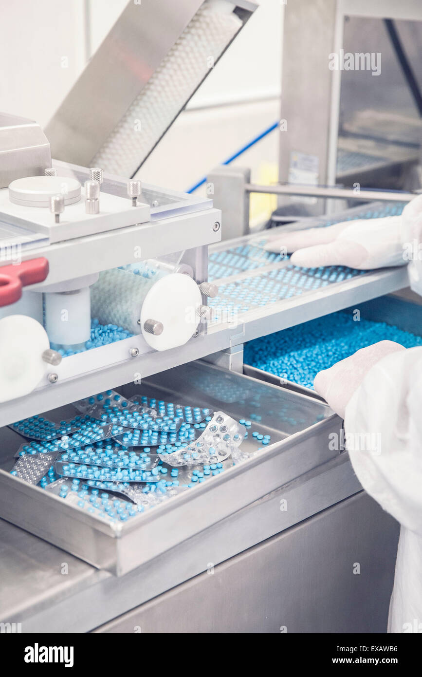 Technician monitoring birth control pill packaging machine Stock Photo ...