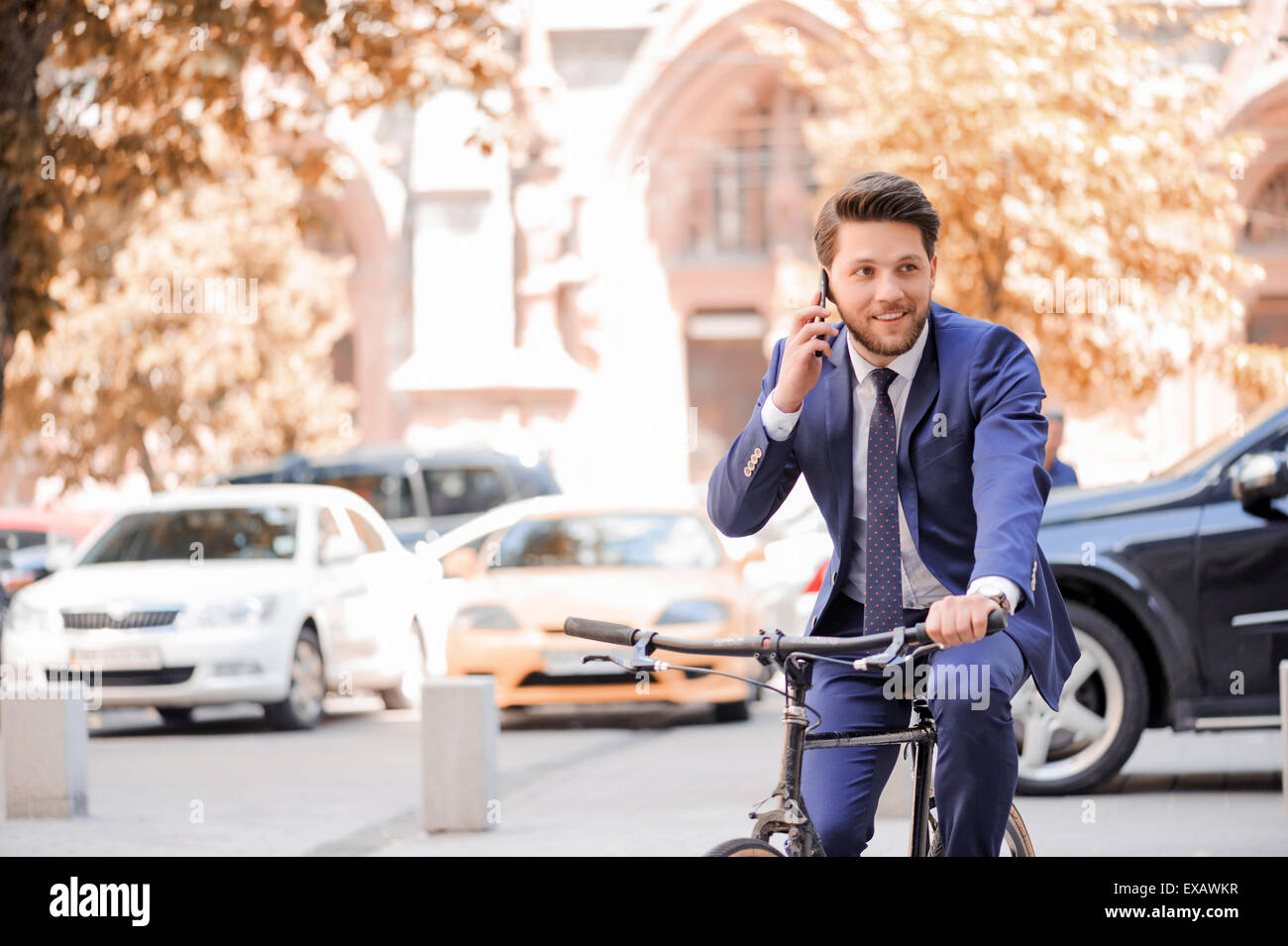 Handsome businessman riding his bicycle Stock Photo - Alamy