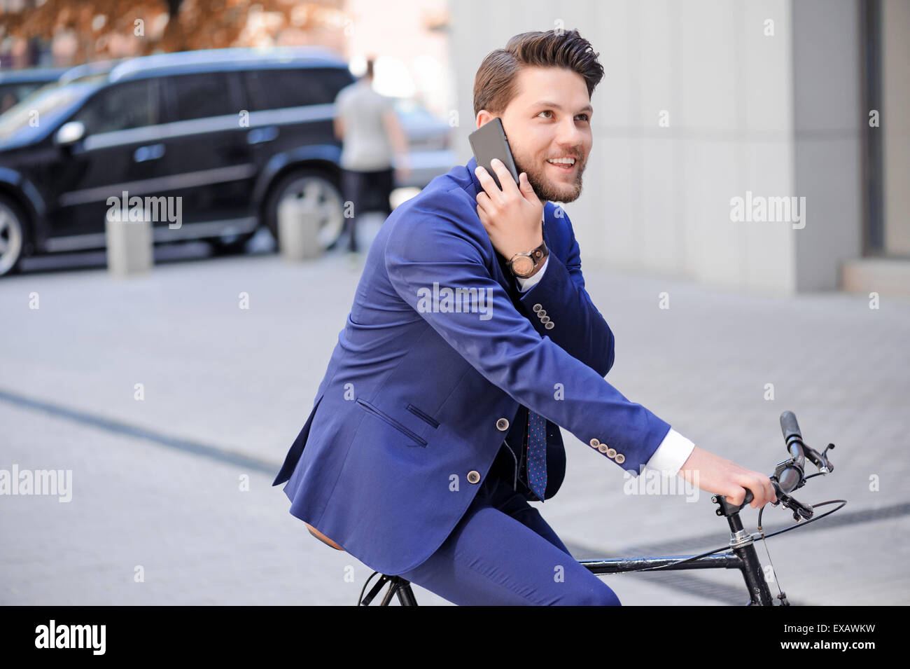 Handsome businessman riding his bicycle Stock Photo - Alamy