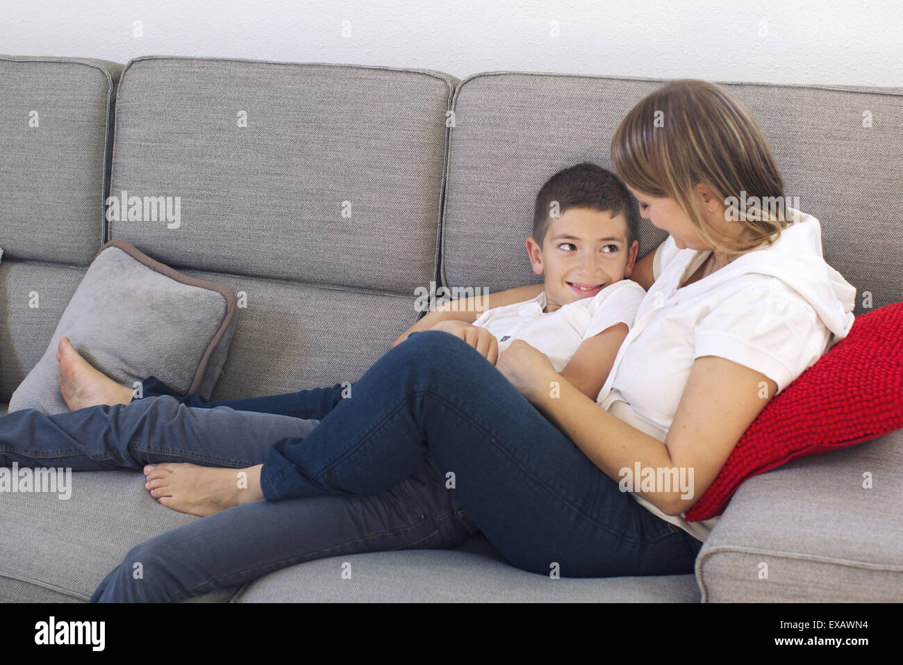 Mother and son relaxing together on sofa Stock Photo - Alamy
