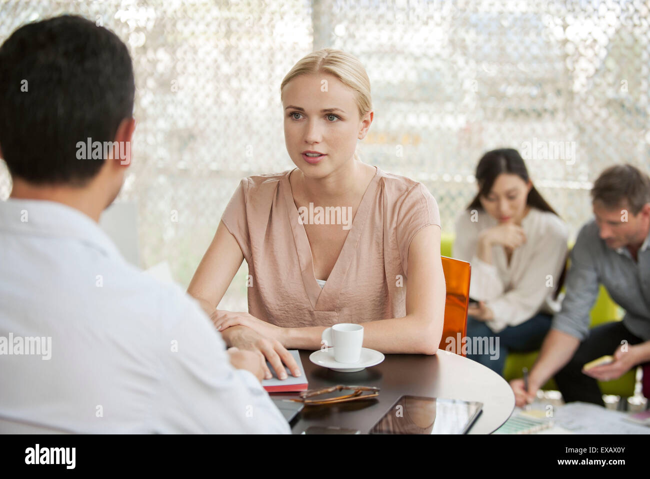 Young professionals having conversation hi-res stock photography and ...
