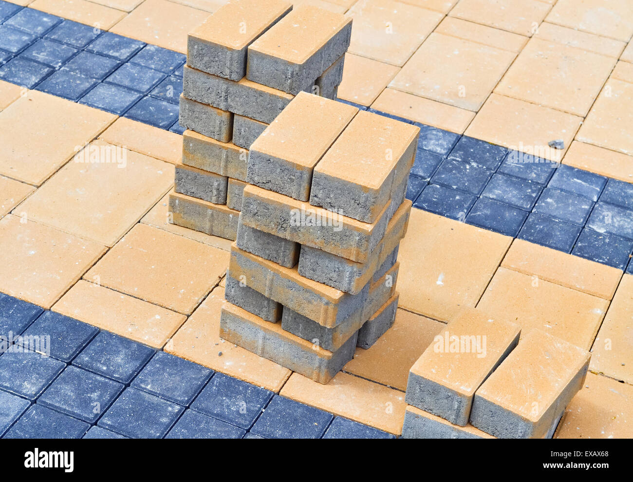 Pile of yellow bricks and paved pedestrian path Stock Photo - Alamy