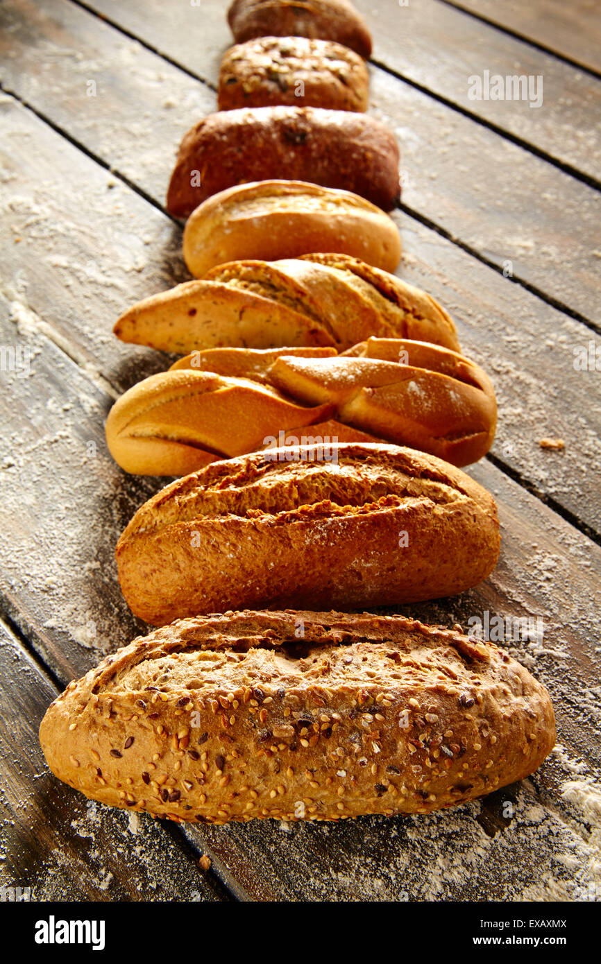 Breads varied in a row on rustic wood table with wheat flour Stock ...