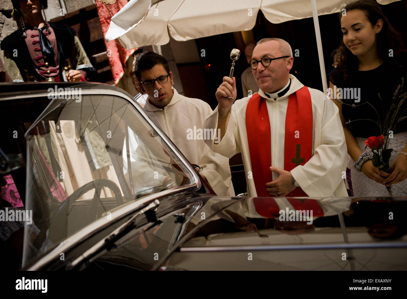 In the Gothic Quarter of Barcelona a priest blesses a classic car on ...