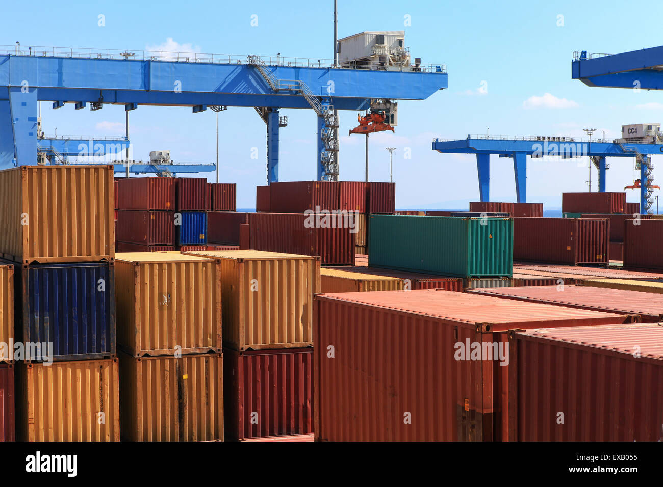 Various brands and colors of shipping containers stacked Stock Photo ...