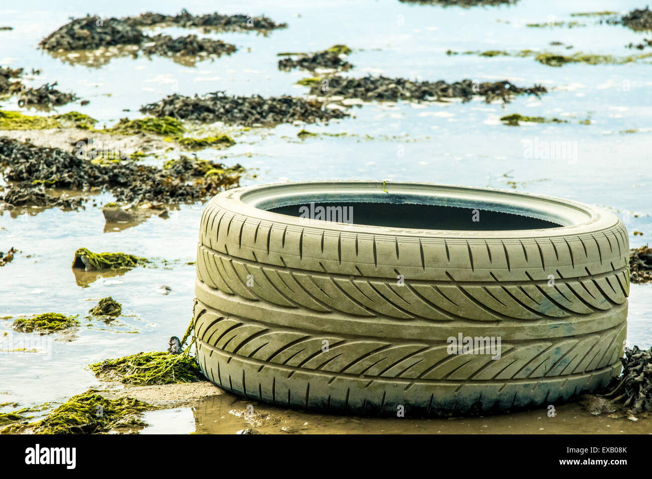 Dumped Tyre on beach at Hayling Island, SOuth Coast, UK Stock Photo - Alamy