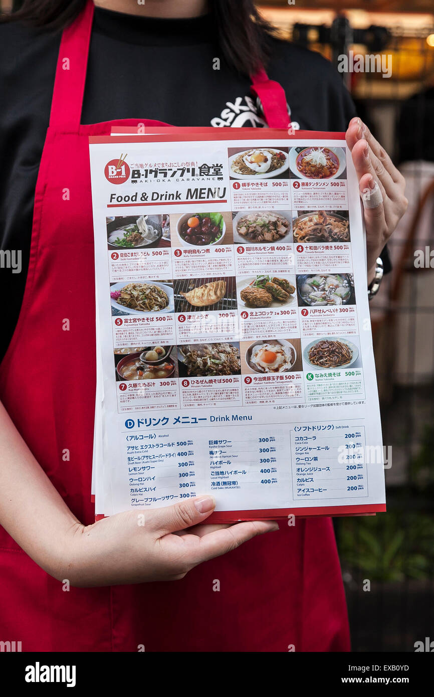 A member of staff shows a menu at the ''B-1 Grand Prix Cafe'' under the ...