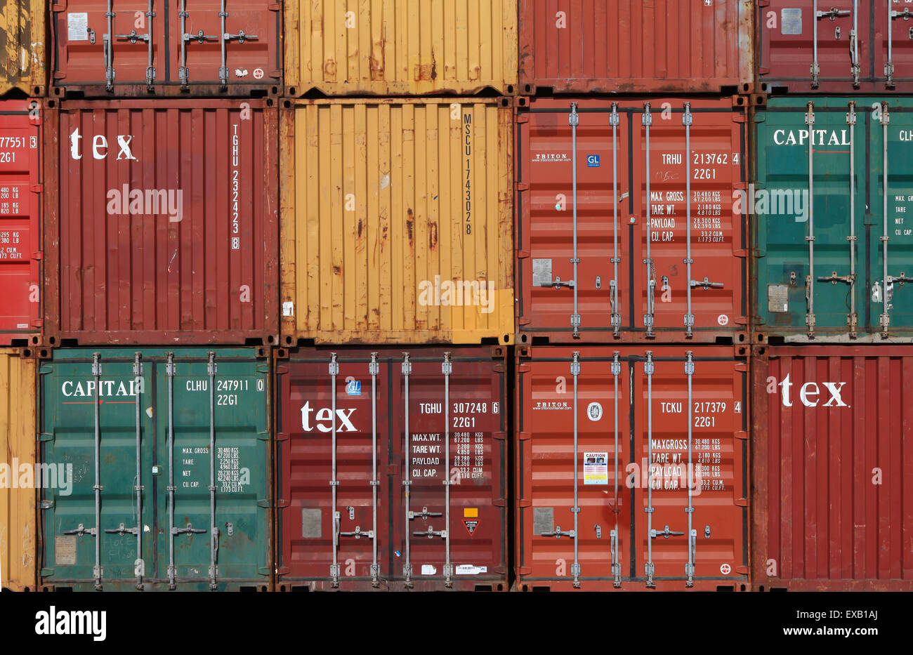 Various brands and colors of shipping containers stacked Stock Photo ...