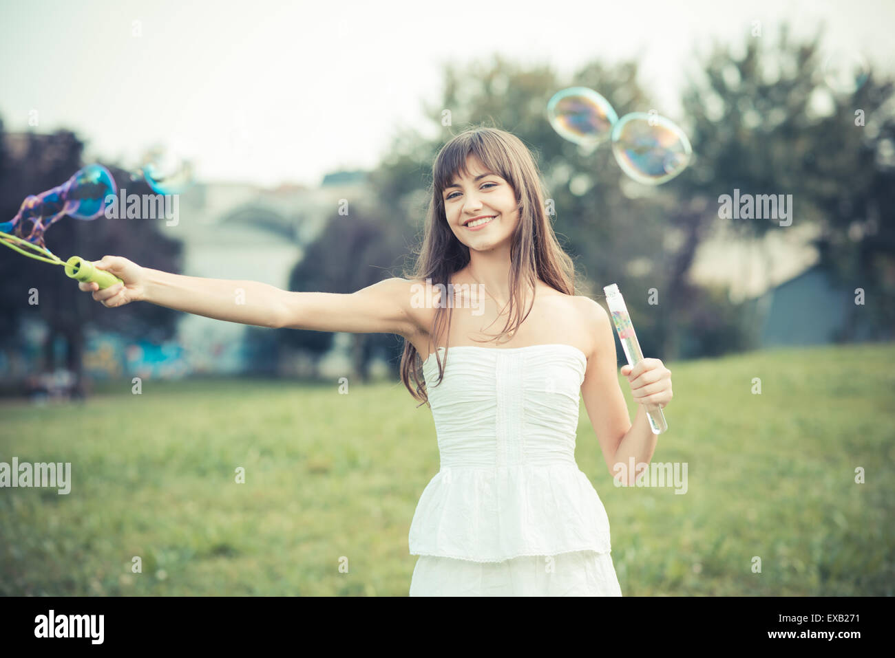Attractive young woman blowing bubble hi-res stock photography and ...