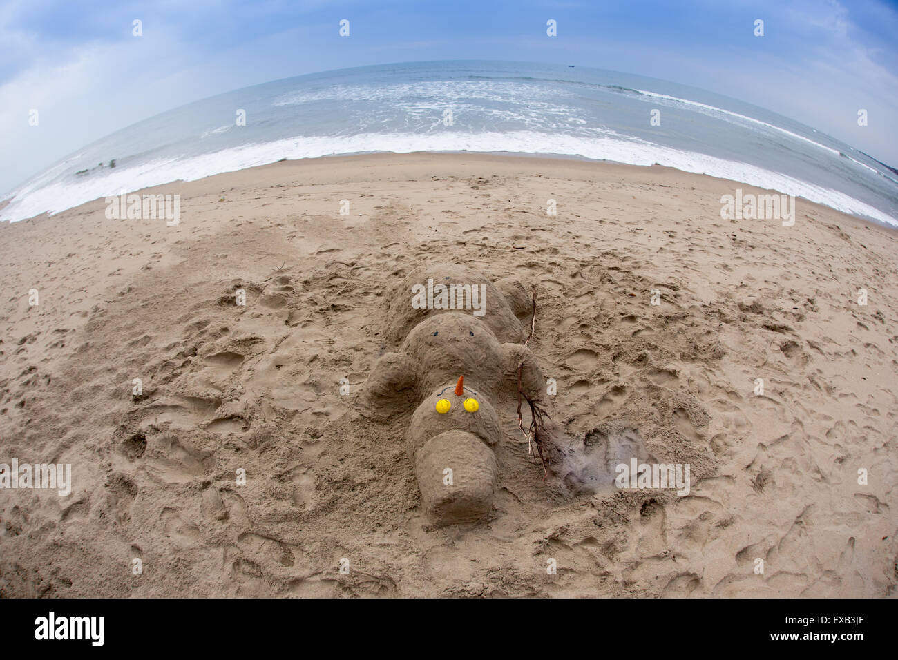 Smiling sandy snowman on the sea beach Stock Photo - Alamy
