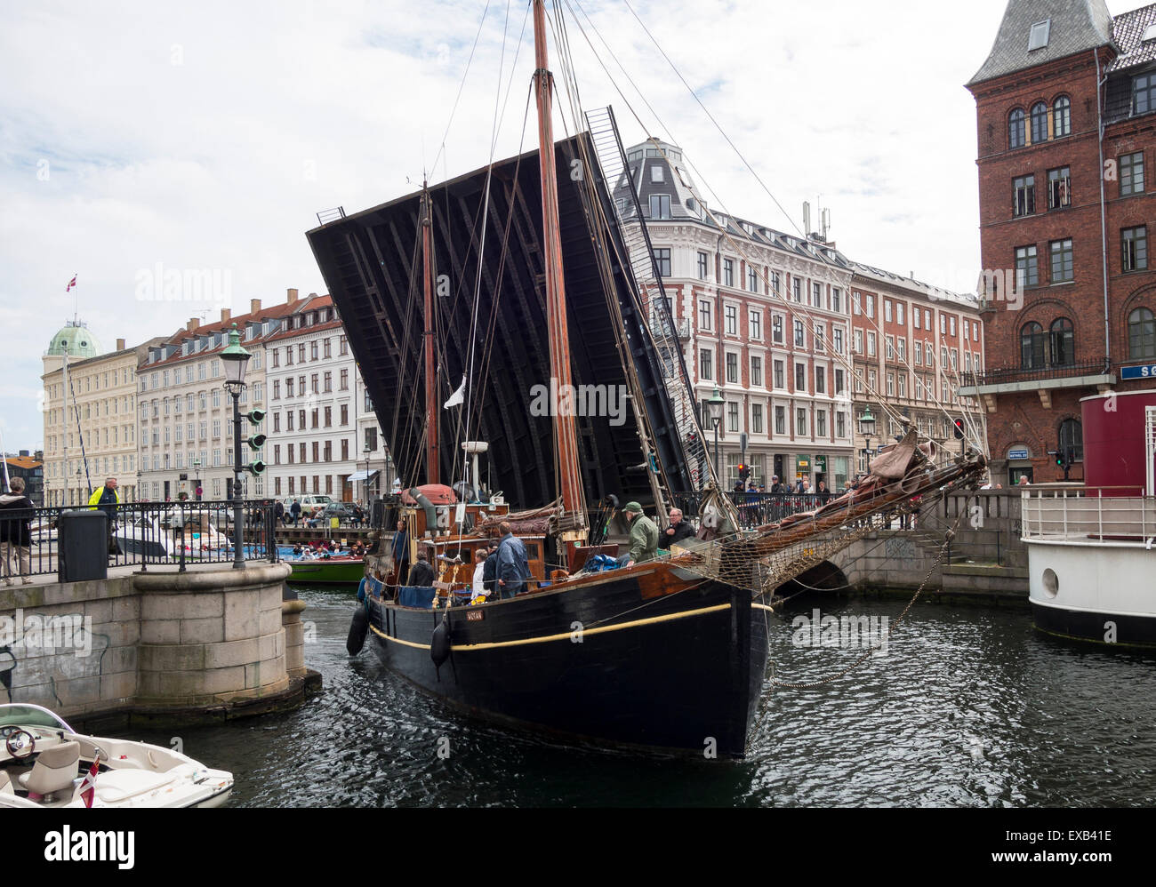 bridge opens for a traditional sailing boat in the Nyhavn harbour area ...