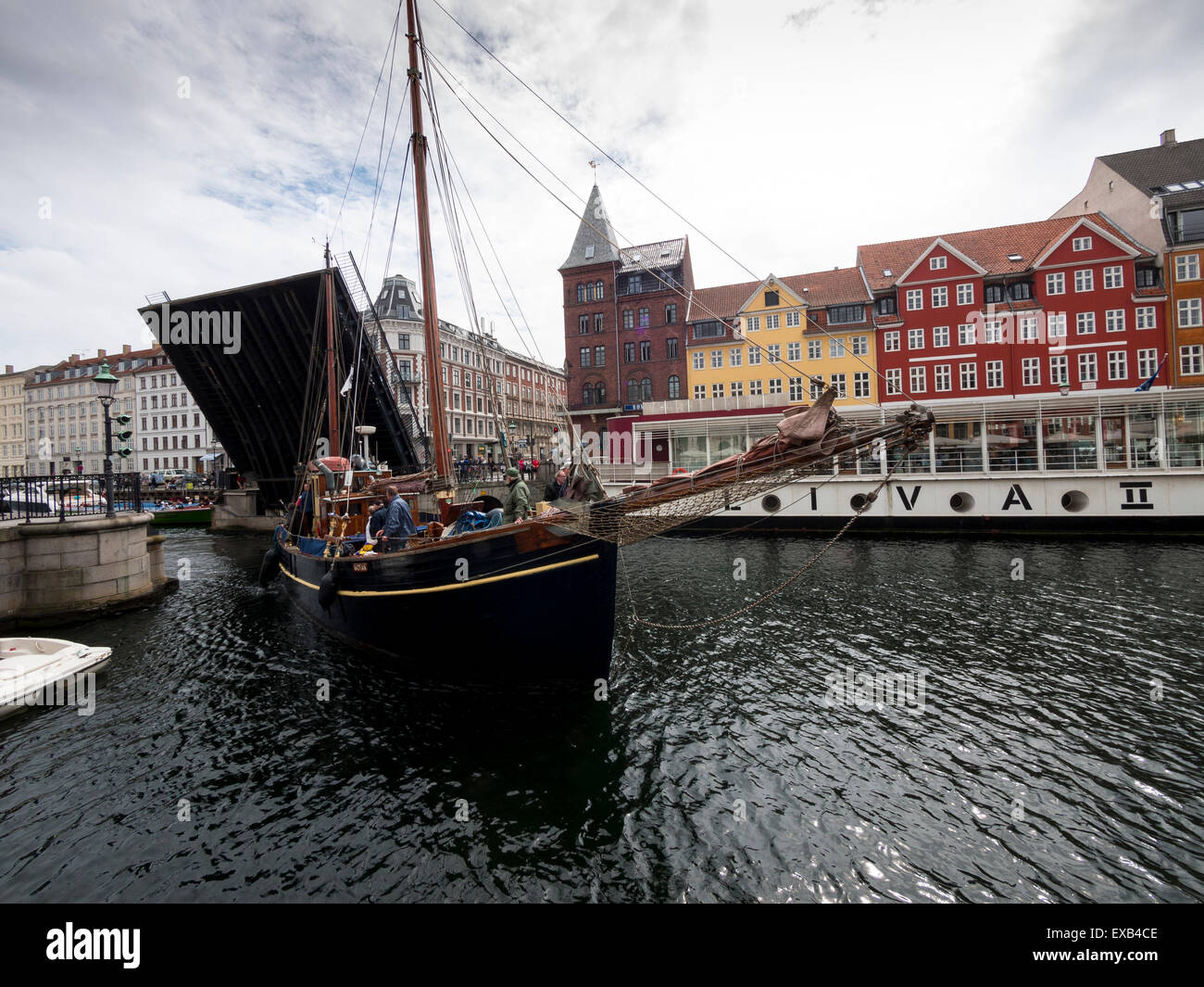 bridge opens for a traditional sailing boat in the Nyhavn harbour area ...