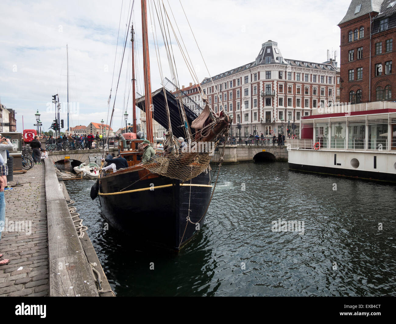 bridge opens for a traditional sailing boat in the Nyhavn harbour area ...