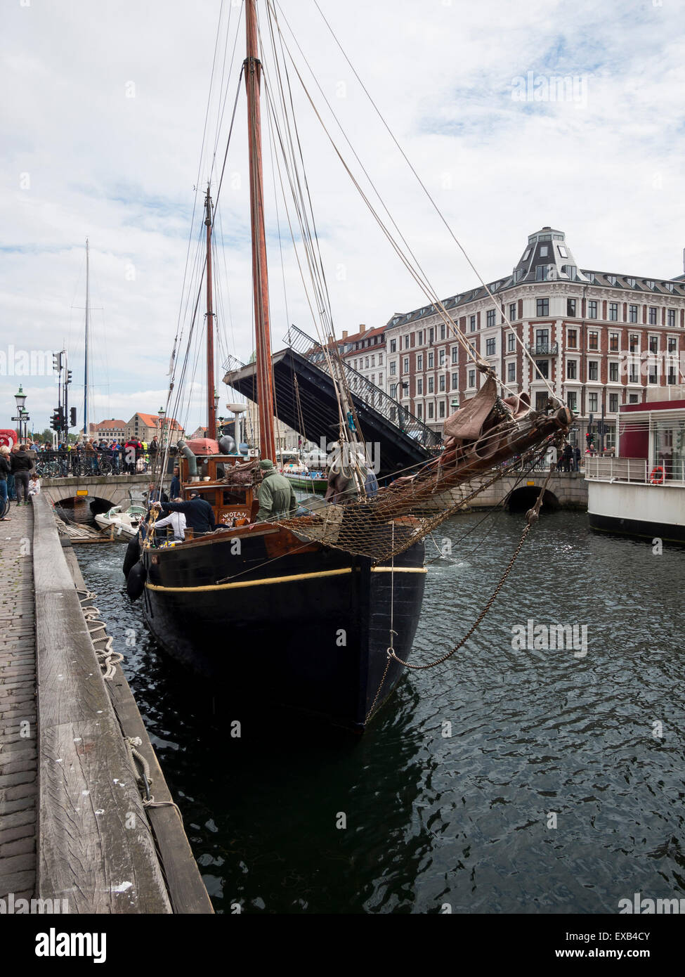 bridge opens for a traditional sailing boat in the Nyhavn harbour area ...