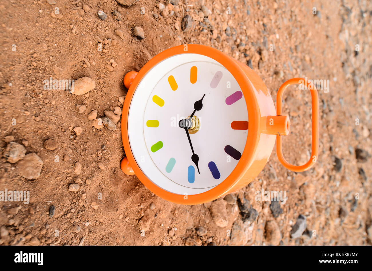 Classic Analog Clock In The Sand Stock Photo - Alamy