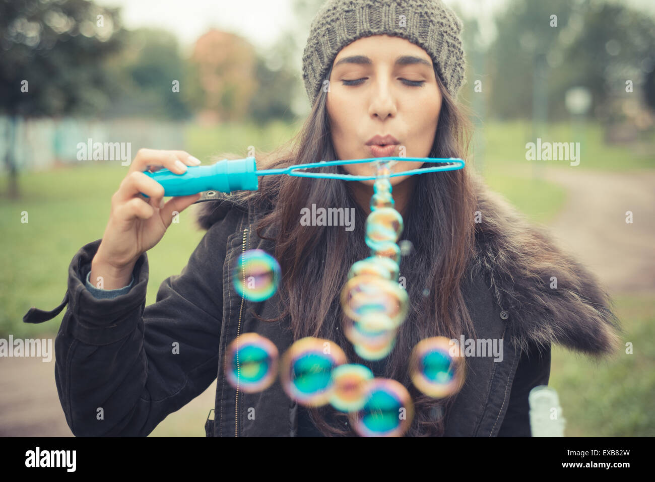 Beautiful female blowing soap bubbles hi-res stock photography and images - Alamy