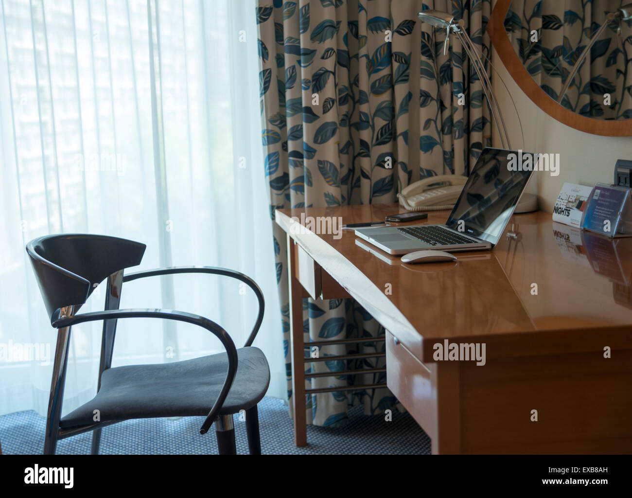 Hotel room with laptop and mobile on the table Stock Photo - Alamy