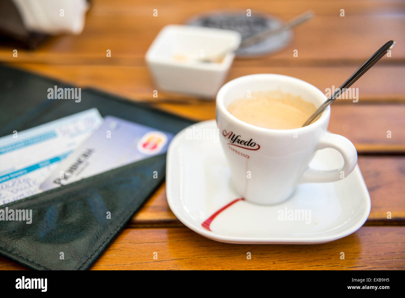 Cup of coffee with the check on the side Stock Photo - Alamy