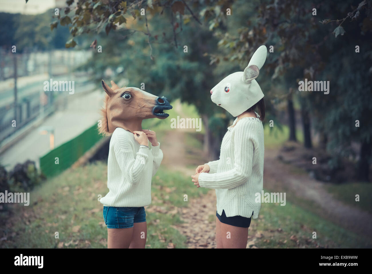 horse and rabbit mask young couple beautiful women girls autumn outdoor ...